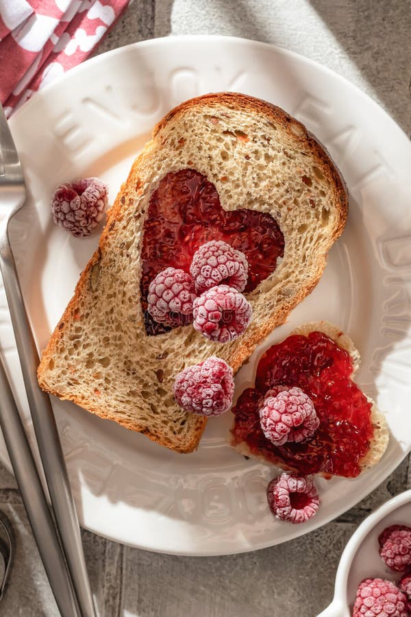 Toasted Bread with Heart-shaped Cut and Raspberry Jam on Tile ...