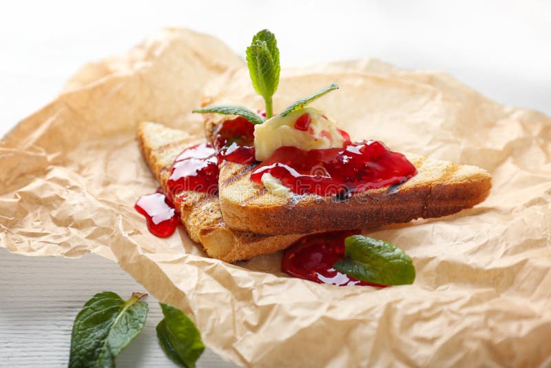 Toasted Bread with Sweet Jam, Butter and Mint on Parchment Stock Photo ...