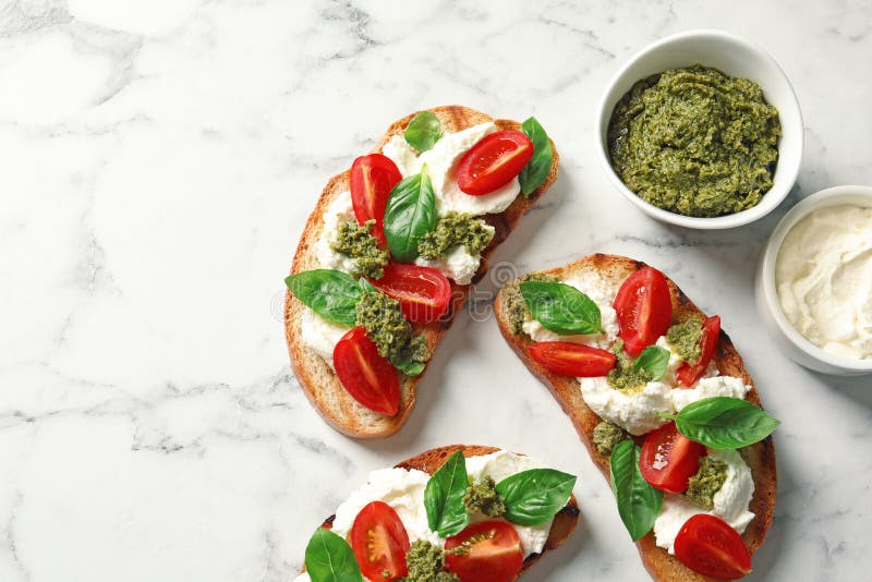 Toasted Bread with Tasty Cream Cheese and Tomatoes on Marble Table ...