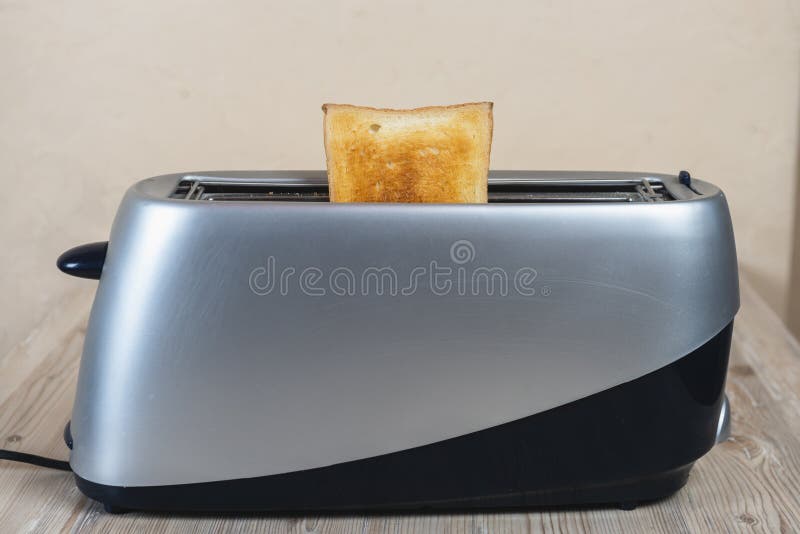 Toasted Bread in Toaster on a Wooden Table with Copy Space Stock Image ...