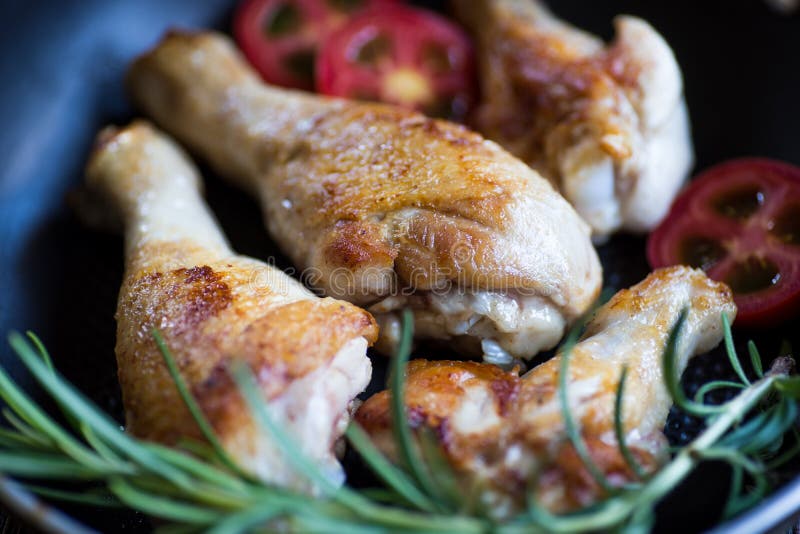 Toasted Chicken Legs with Rosemary and Tomato Stock Photo - Image of ...