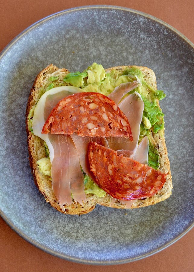 Toasted Multi Grain Bread with Smashed Avocado and Hot Italian Salami ...