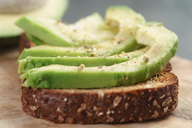 Toasted Rye Bread with Sliced Avocado and Herbs Stock Photo - Image of ...