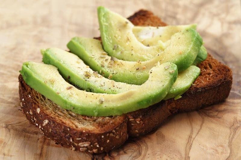 Toasted Rye Bread with Sliced Avocado and Herbs Stock Photo - Image of ...