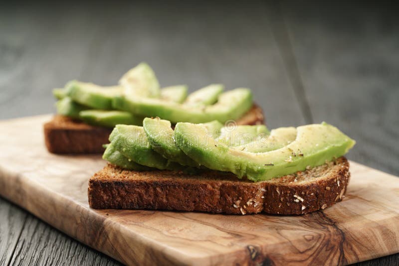 Toasted Rye Bread with Sliced Avocado and Herbs Stock Image - Image of ...
