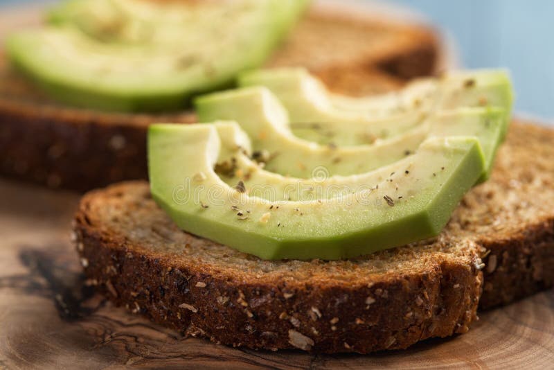 Toasted Rye Bread with Sliced Avocado and Herbs Stock Photo - Image of ...