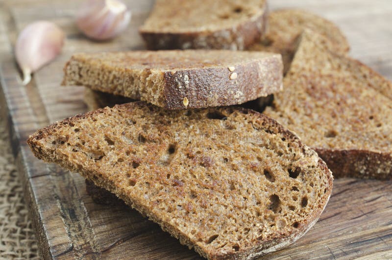 Toasted Rye Bread on a Wooden Board. Rustic Style. Stock Photo - Image ...