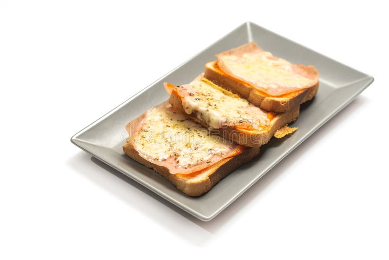 Toasted Sandwiches with Grated Yellow Cheese and Ham on the Plate Stock ...