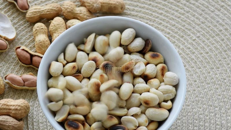 Roasted, Skinless Peanuts Falling into a Small Jar. Side Tracking ...
