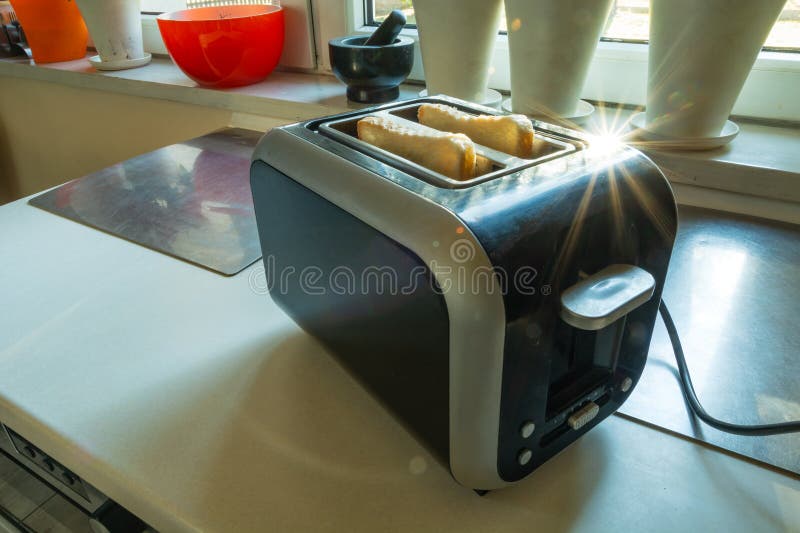 A Toaster with Slices of Toast Standing on the Kitchen Counter Stock ...