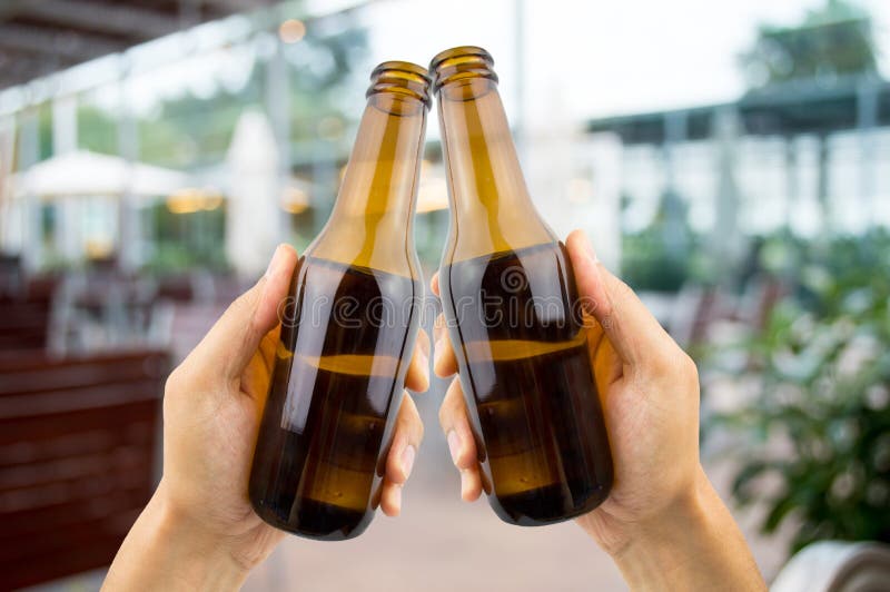 Toasting with Beer at the Bar Stock Photo - Image of holding, hand ...
