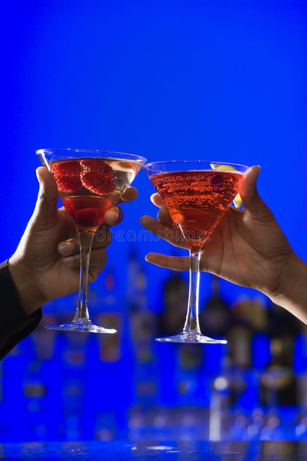 Hands toasting cups. stock image. Image of photograph - 2425489