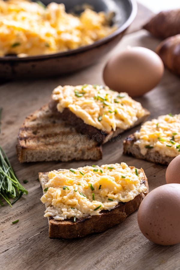 Toasts of Bread with Generous Portion of Scrambled Eggs on Top of it ...