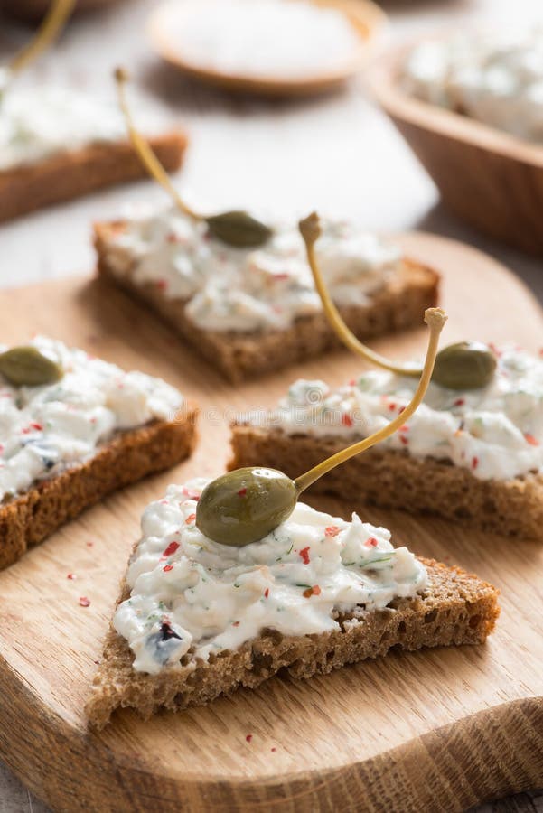 Toasts with Cheese Pate and Capers on a Wooden Board, Close-up Stock ...