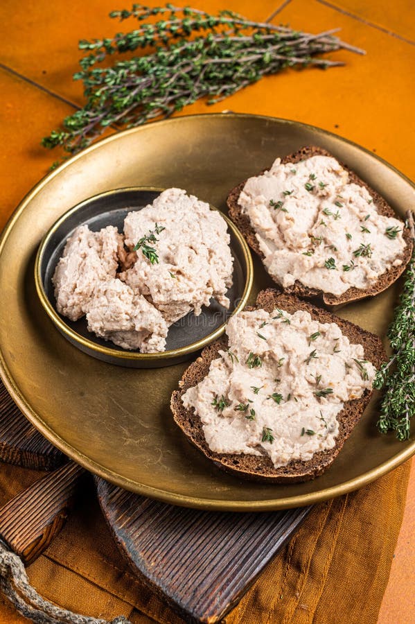 Toasts with Cod Liver Spread Pate on a Plate. Orange Background Stock ...