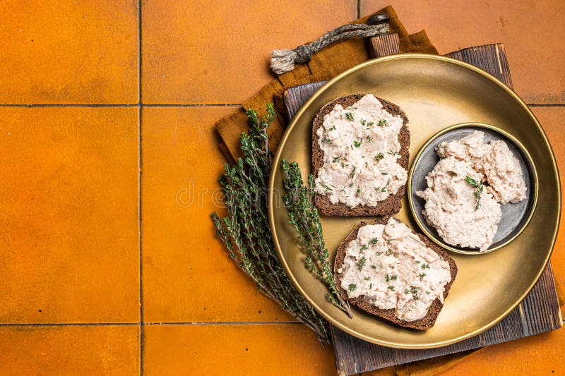 Toasts with Cod Liver Spread Pate on a Plate. Orange Background. Top ...