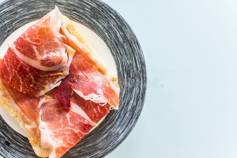 Toasts with Ham Serrano Served on Plate Stock Photo - Image of homemade ...