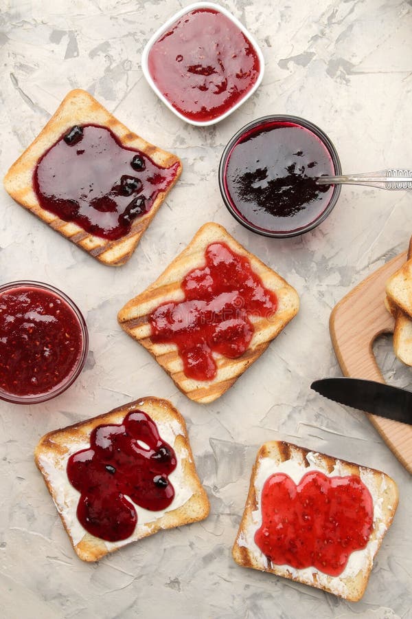 Toasts with Jam. Fried Crispy Toasts with Red Jam on a Light Concrete ...