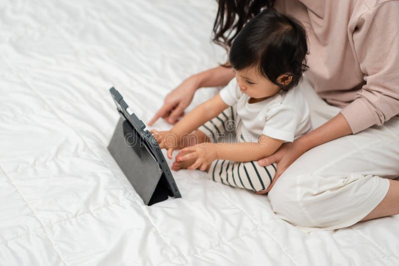 Toddler Baby with Mother Using Digital Tablet Pc on Bed Stock Photo ...