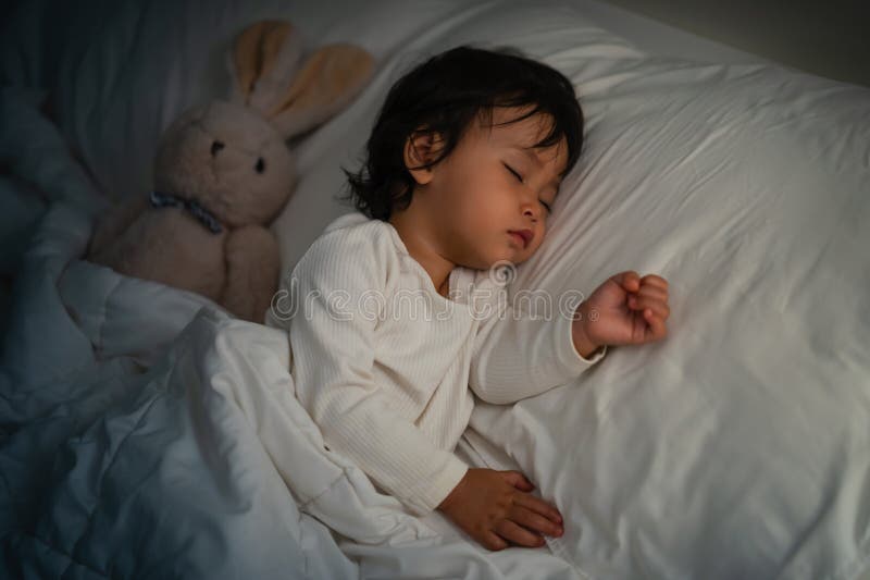 Toddler Baby Sleeping with Teddy Bear on Bed at Night Stock Photo ...