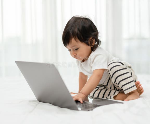 Toddler Baby Using Laptop Computer on Bed Stock Image - Image of ...