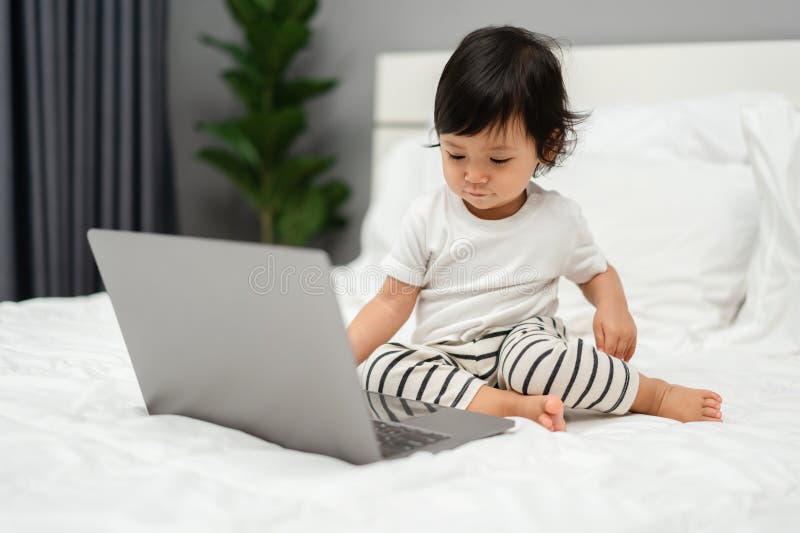 Toddler Baby Watching Laptop Computer on Bed Stock Image - Image of ...