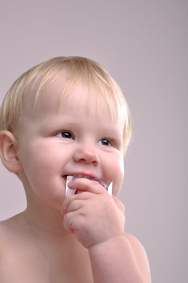 Toddler biting a toy stock image. Image of person, babyhood - 21967469