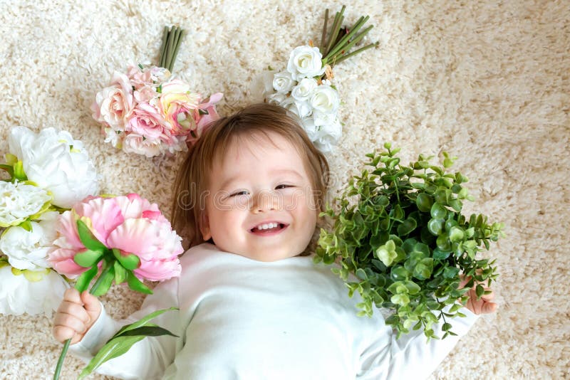 Toddler boy with flowers stock image. Image of multiethnic - 143644187