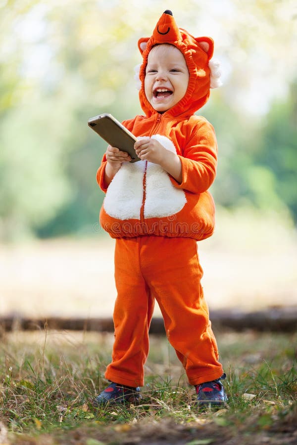 Toddler Boy in Fox Costume Holding Smartphone Stock Image - Image of ...