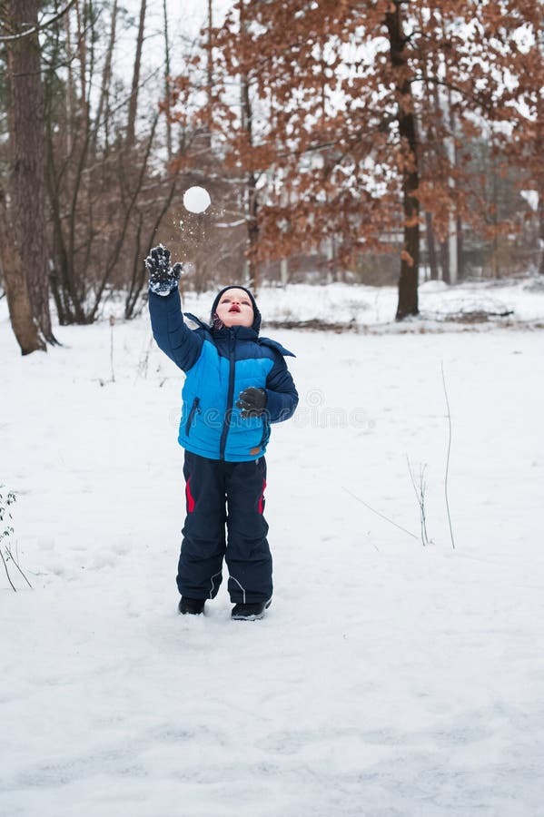 Toddler Boy Playing Snowballs. Winter Outdoor Activity Stock Photo ...