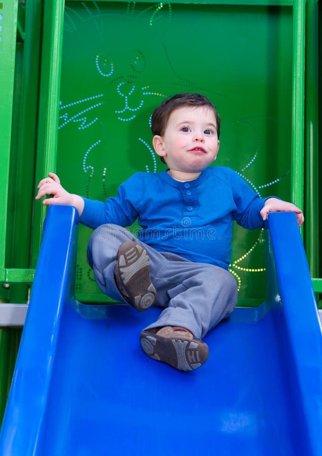 Toddler Boy Smiling on a Slide Stock Image - Image of cute, looking ...
