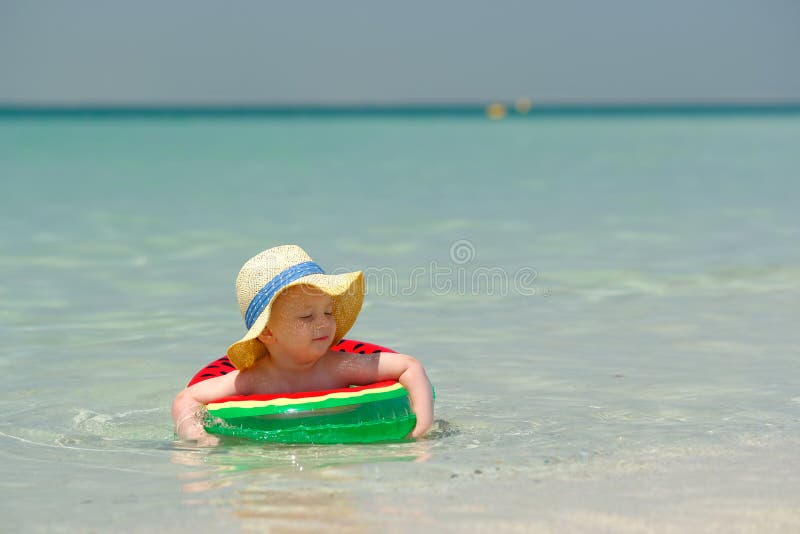Toddler Boy with Swim Ring on Beach Stock Image - Image of blue ...