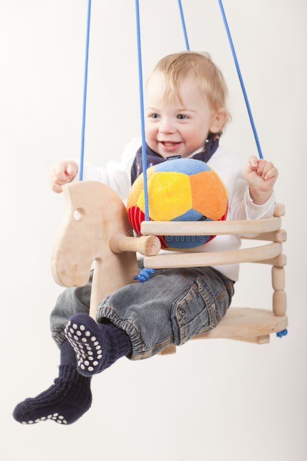 Toddler boy in swing stock photo. Image of childhood - 18048456