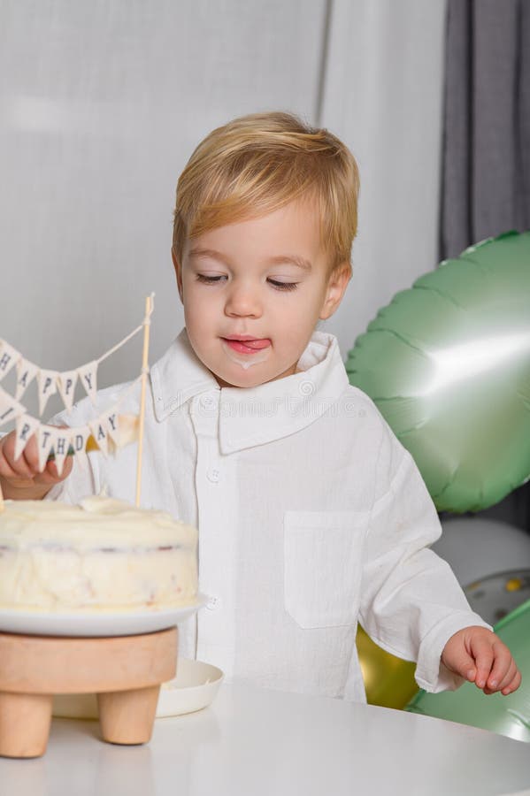 Toddler Celebrating Second Birthday with Cake and Balloons Stock Image ...