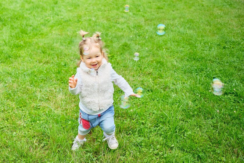 Toddler Chasing Soap Bubbles through a Summer Park Stock Image - Image ...