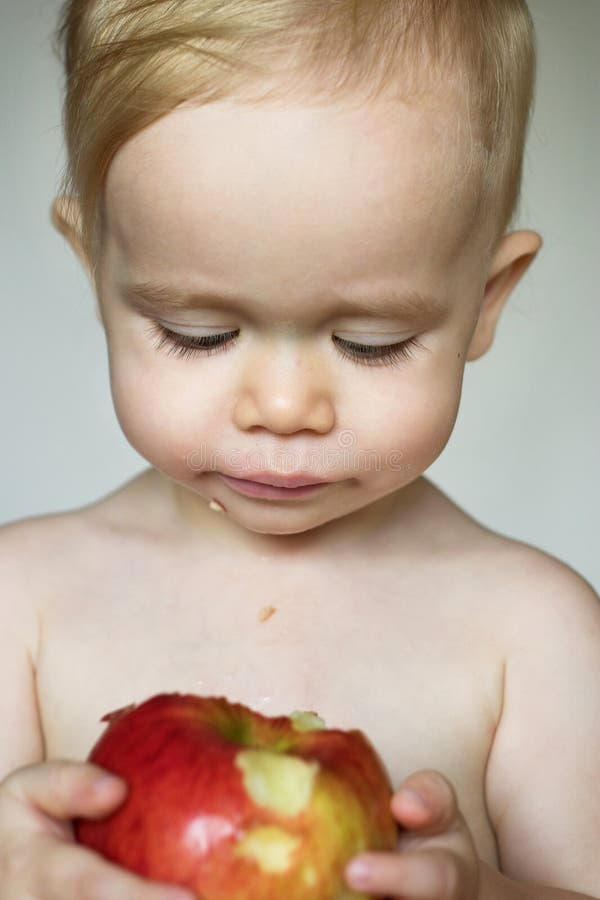 Toddler Eating Apple stock photo. Image of handsome, expression - 3026000