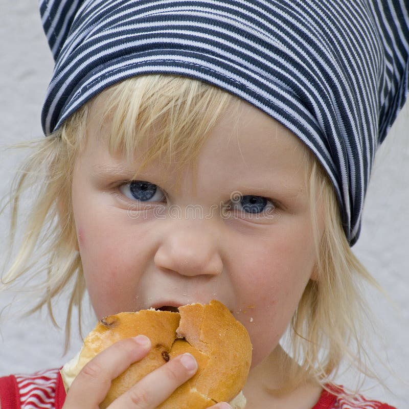Toddler eating bread roll stock image. Image of charming - 5873157