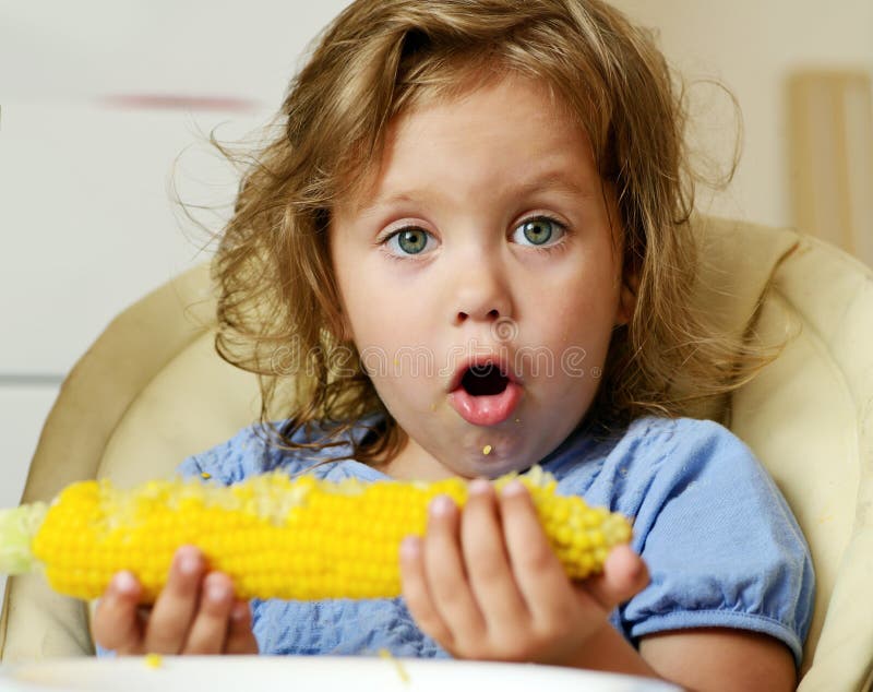 Toddler eating corn stock image. Image of home, cooked - 42419777