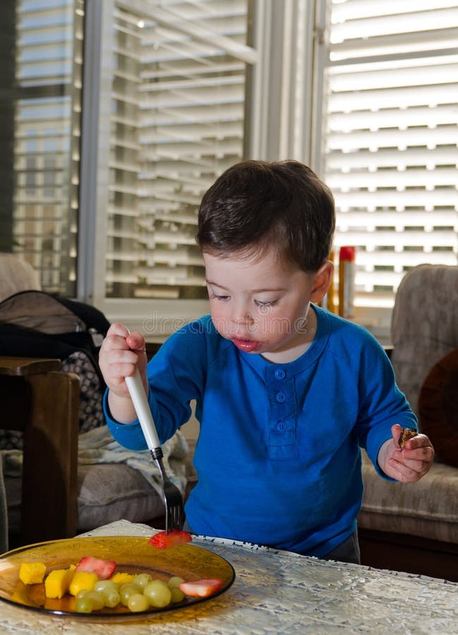 Toddler eating with a fork stock photo. Image of israeli - 37412238