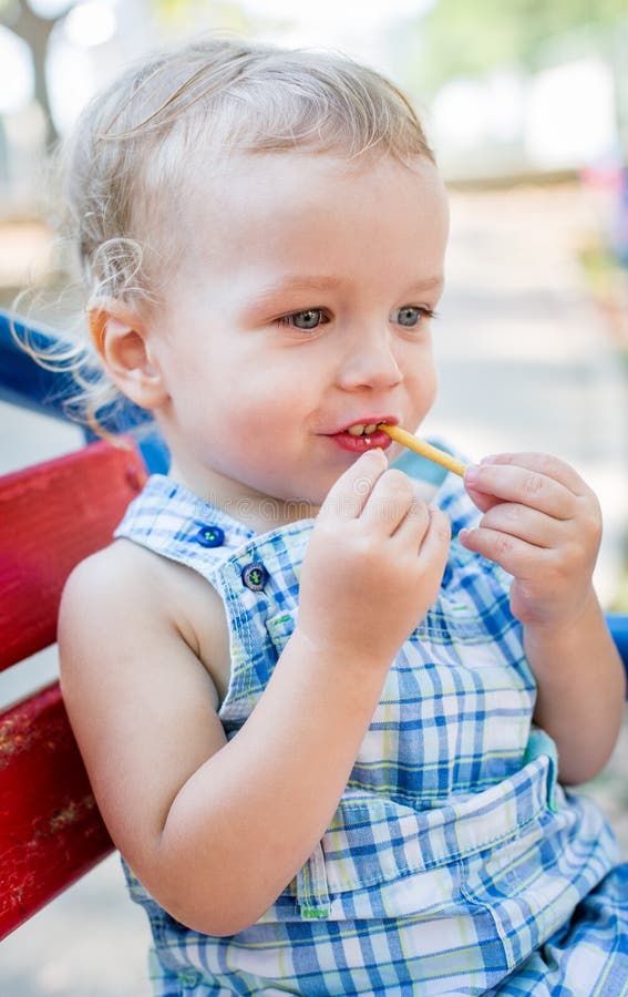 Toddler eating sweet straw stock image. Image of hand - 43539025