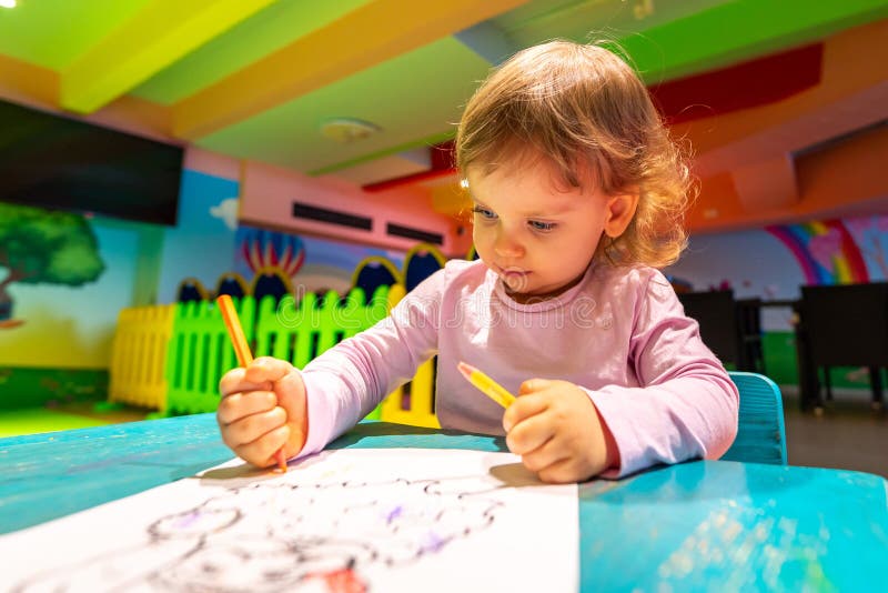 Toddler Engrossed in Drawing while Exploring Creativity in a Colorful ...