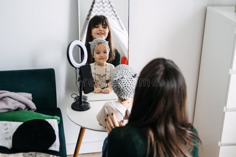 Toddler Exploring Self-discovery through Mirror Play with Mother. Child ...