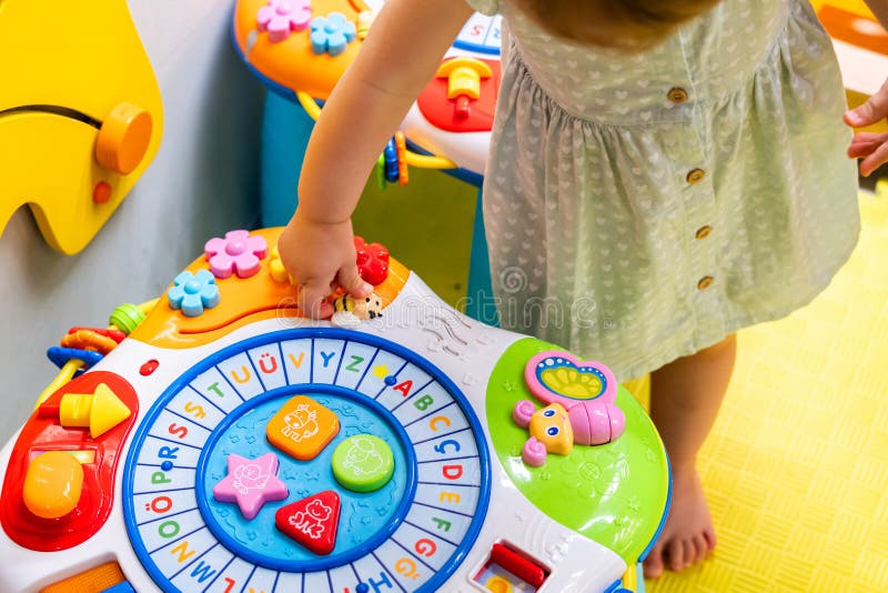 Toddler Exploring Shapes and Colors on Activity Table. Concept of ...