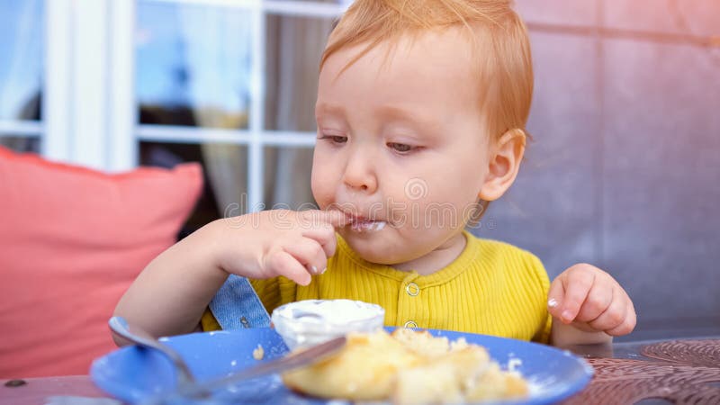 Toddler Funny Dips Hands into Saucy Food and Eats at Table Stock Photo ...
