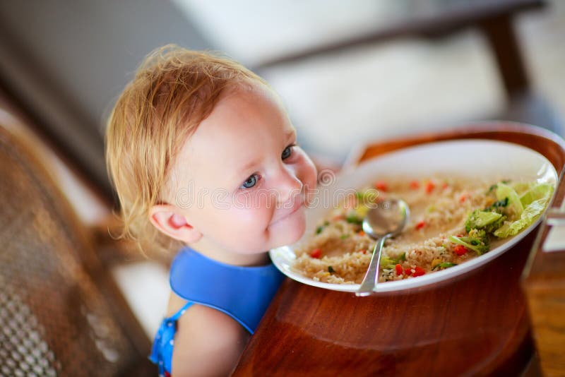 Toddler girl eating lunch stock image. Image of girl - 16310557