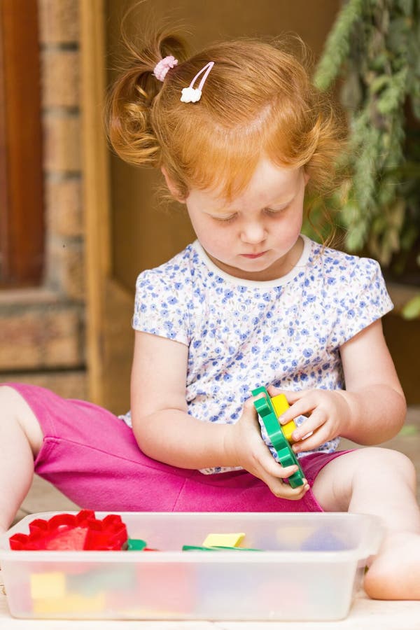 Toddler girl playing toys stock photo. Image of educational - 65410842