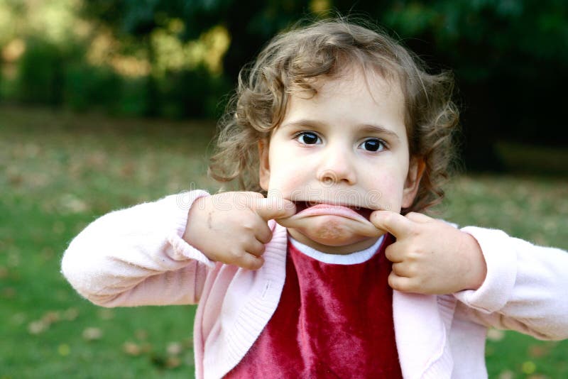 Toddler Girl Pulling Funny Faces Stock Photo - Image of funny, mouth ...