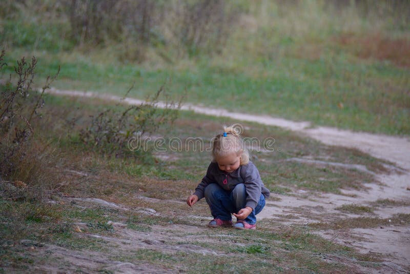 Toddler Girl Sitting On The Forest Path Stock Photo - Image of look ...