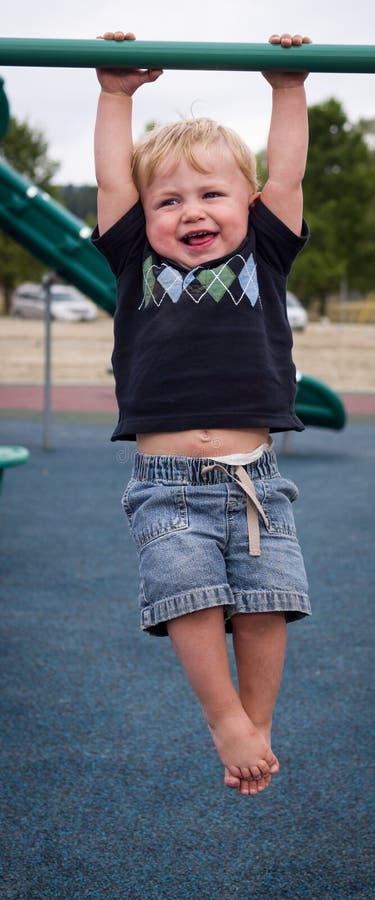 Toddler hanging from bars stock image. Image of monkey - 26473561