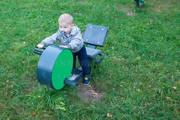 Toddler Interacting with Playground Equipment. he is Learning ...